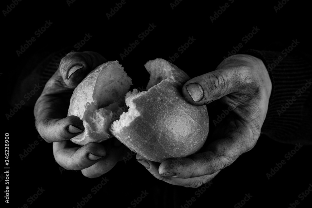 Helping hand giving a piece of bread. Poor Man dividing and sharing ...
