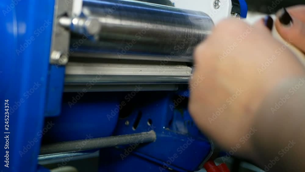 Chef making dough pastry sheeter. Baker forming shaping dough rolled ...