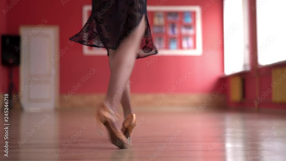 Close-up picture of woman's legs who is dancing in solo in an empty ...