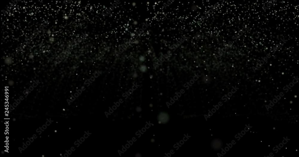 explosion of particles that create a cloud of dust on a black ...