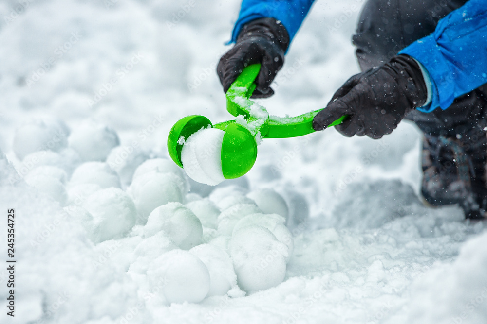 Snowball game. Children make snowballs. Stock Photo | Adobe Stock