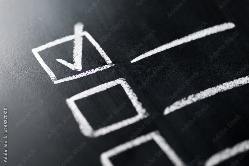 Check list on blackboard macro close up. Document of finished work ...