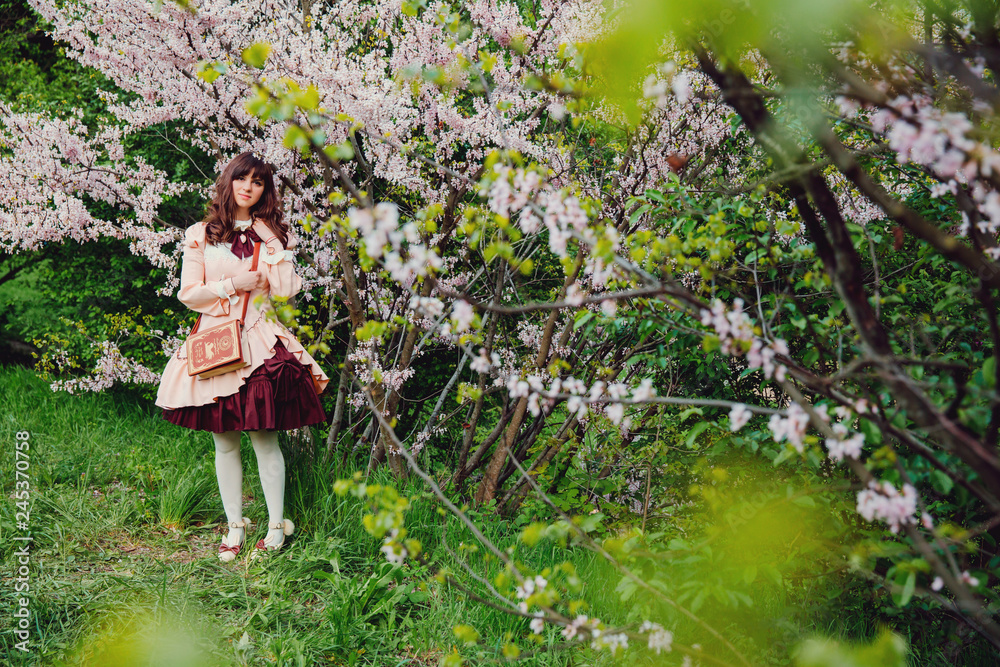 Beautiful girl in a vintage dress. Spring flowers. Lolita style ...