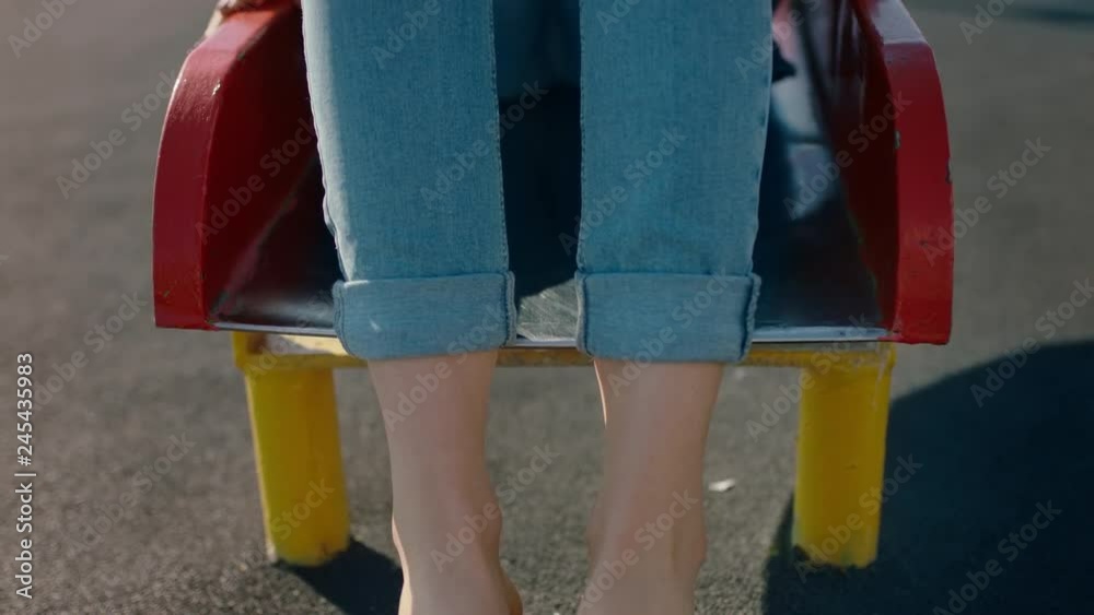 close up feet woman sliding on playground slide enjoying fun on summer ...