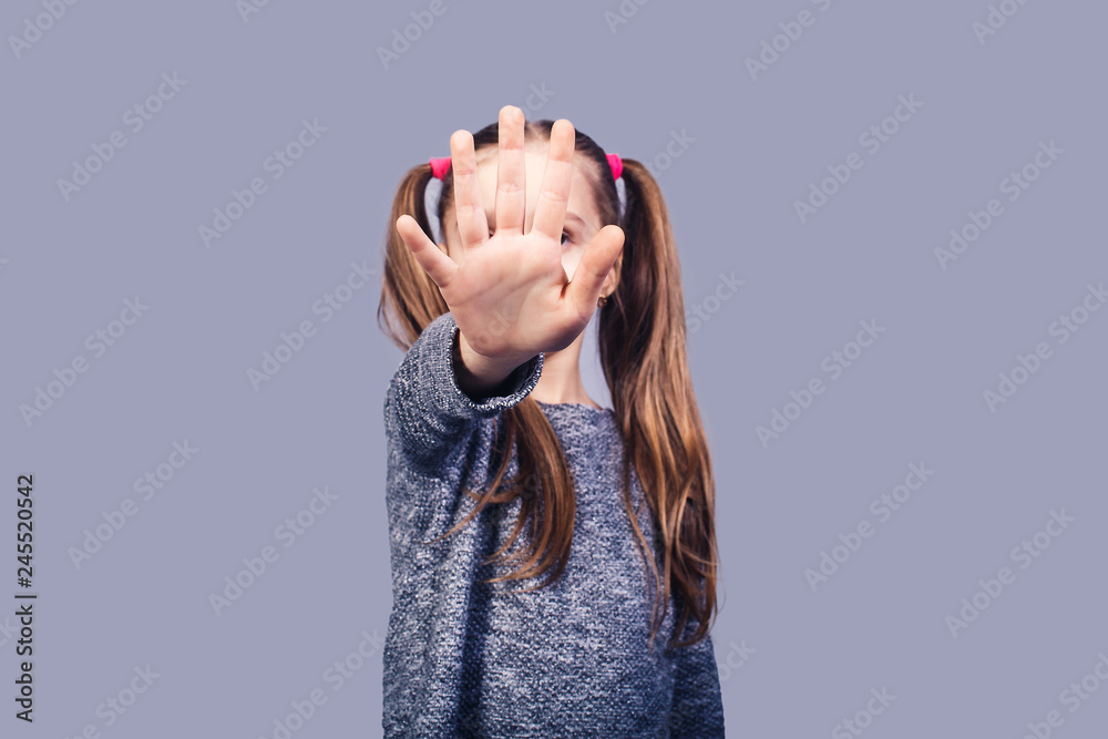 sad little girl shows hand stop sign. Concept stop child abuse. Stock ...