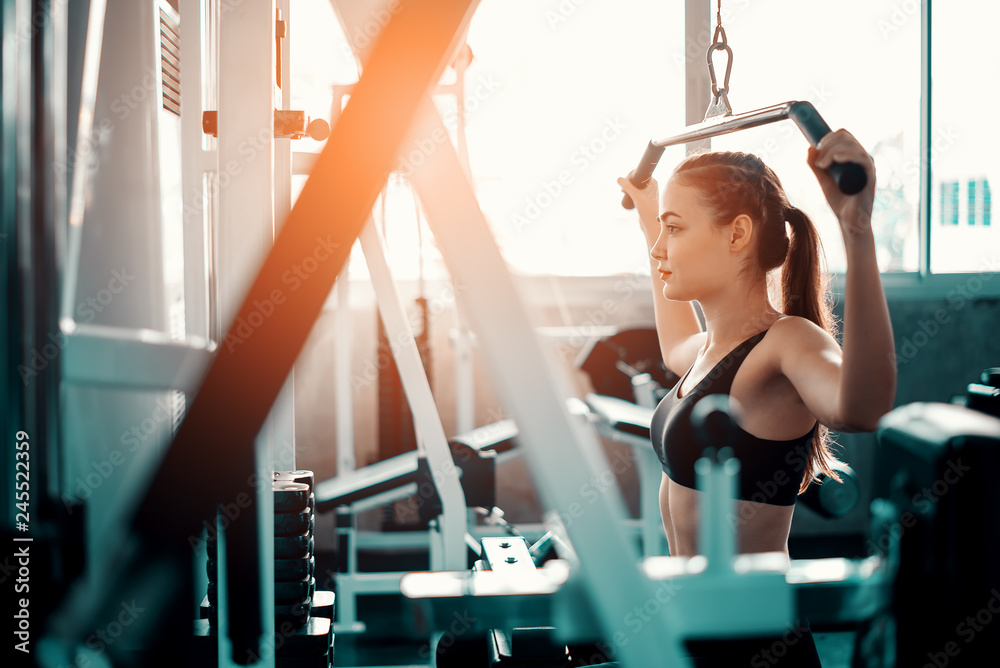 Beautiful muscular sporty caucasian woman exercising building muscle ...