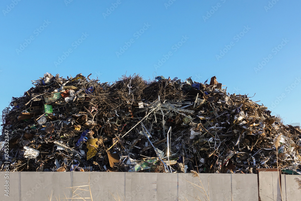 large pile of collected scrap metal on the territory of the metal ...