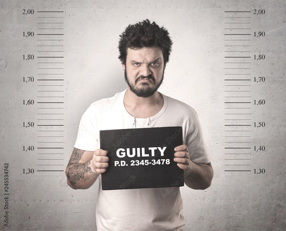Caught guilty man with ID signs on his hand. Stock Photo | Adobe Stock