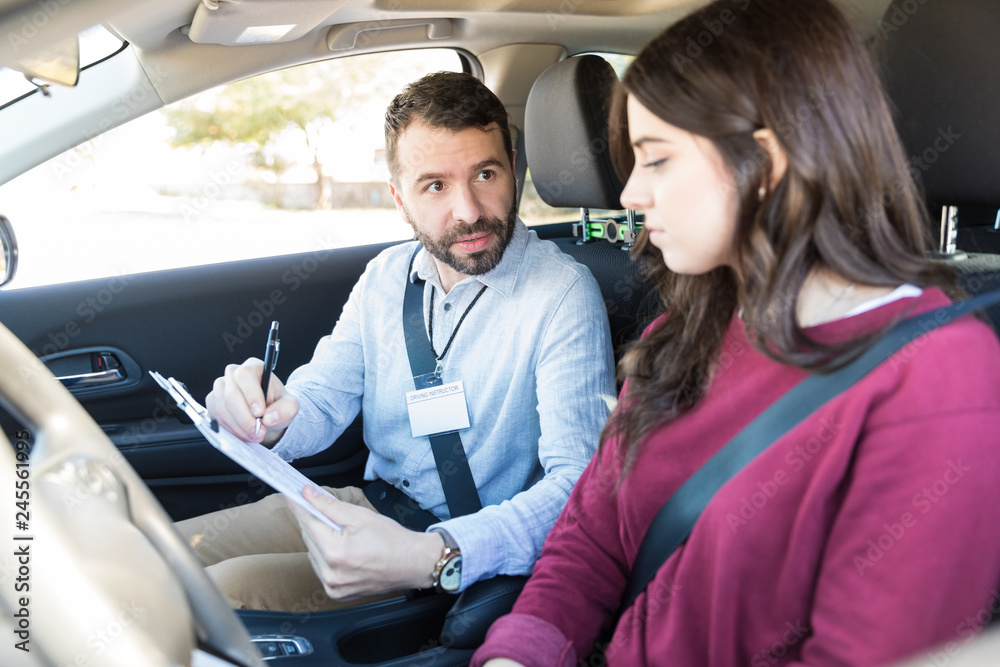 Trainer Explaining Checklist To New Car Driver Stock Photo | Adobe Stock