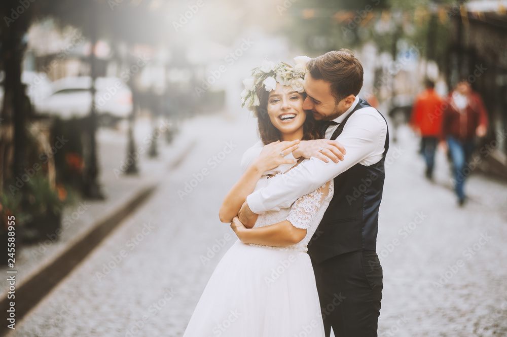 Handsome loving couple, wife and husband, hugs tender his wife from ...
