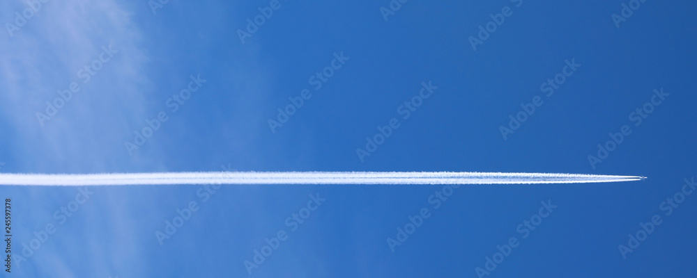 Engine exhaust white contrails forming behind an aircraft Stock Photo ...