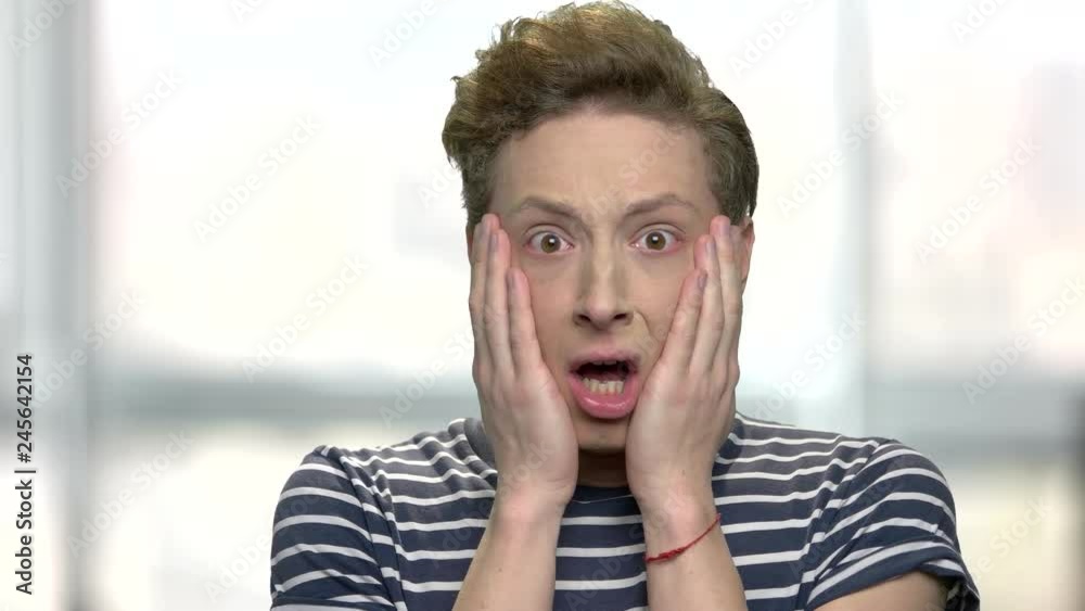 Close up shocked face of teenage boy. Emotional portrait of scared teen ...