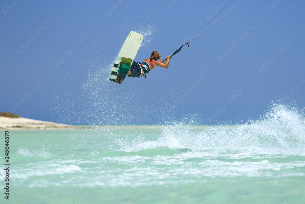 Professional kite boarding rider sportsman with kite in sky jumps high ...