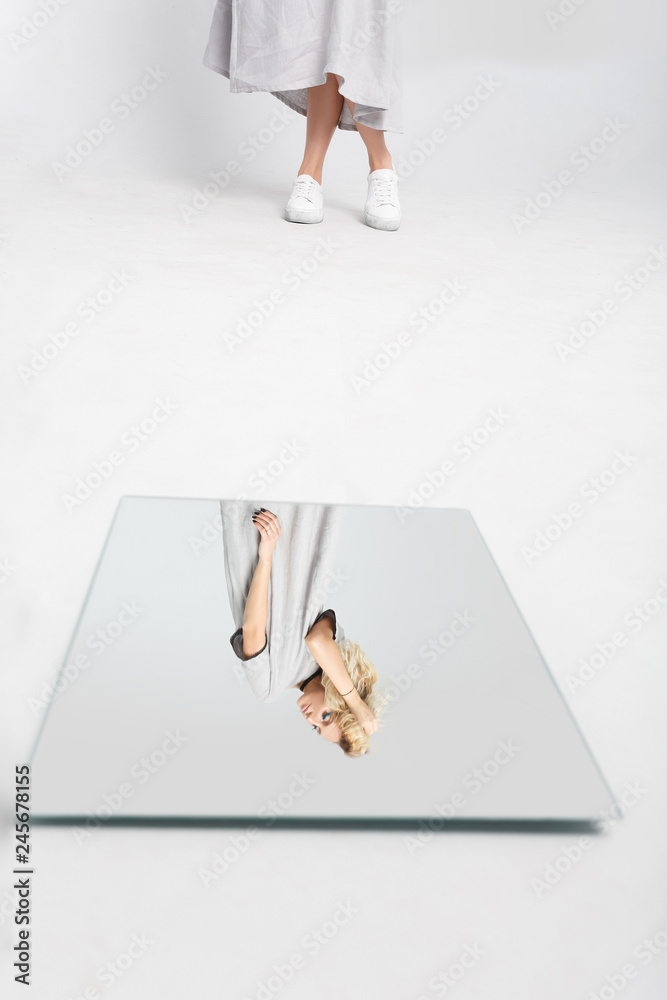 Beautiful Girl in Fashion wear on mirror reflection floor on white ...