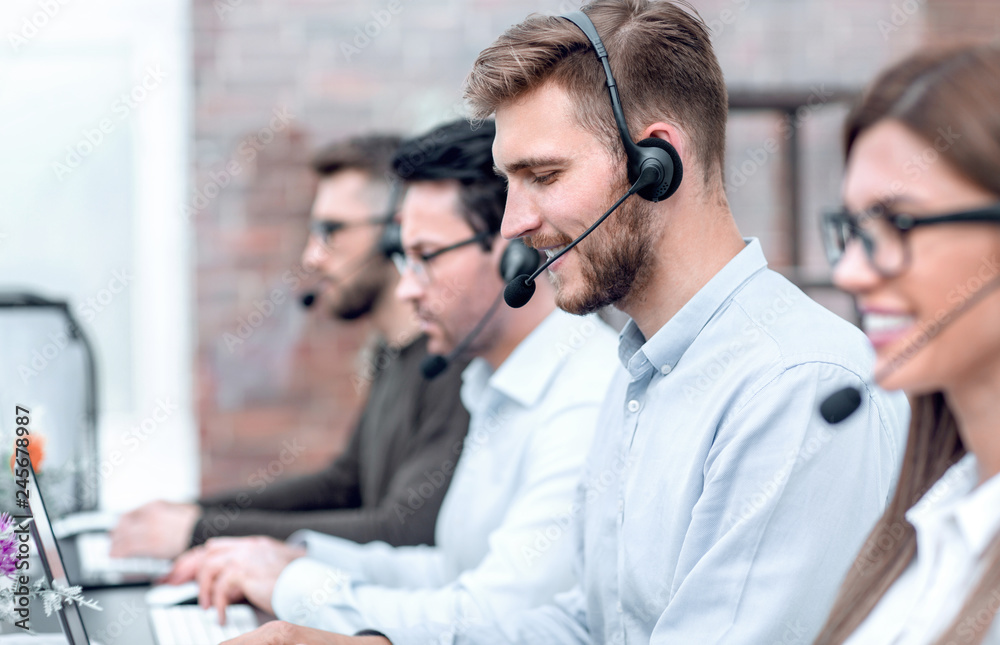 side view.the call center operator and her colleagues work in the ...