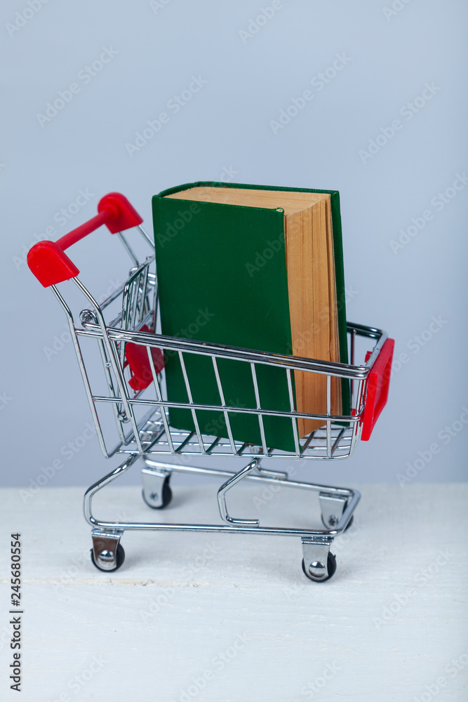 Book in a shopping cart Stock Photo | Adobe Stock