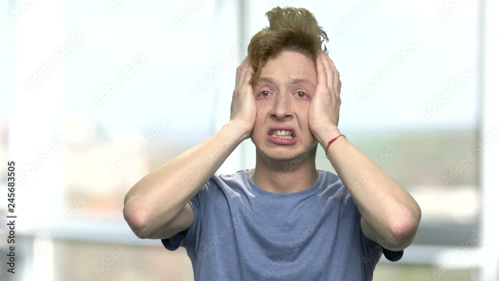 Portrait of teenage boy in full despair. Desperate stressed teen boy ...