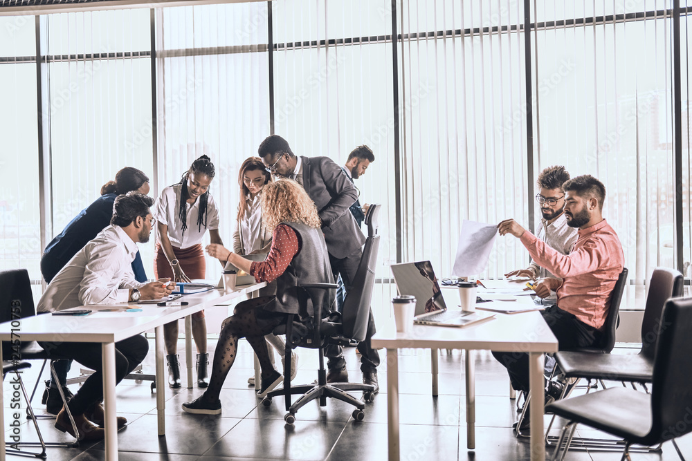 Interior of busy office with diveres young people.young office people ...