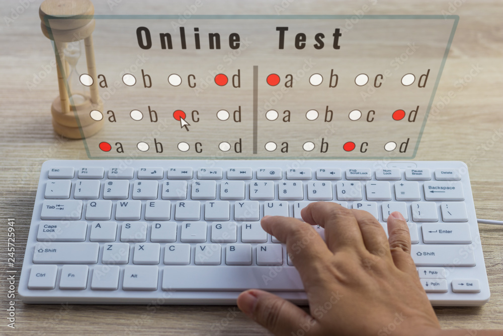 Dry hands of adult student using white keyboard on wood table to do ...