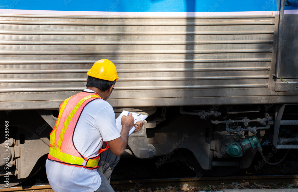 Picture of Asian engineer wearing safety helmet with checking train for ...