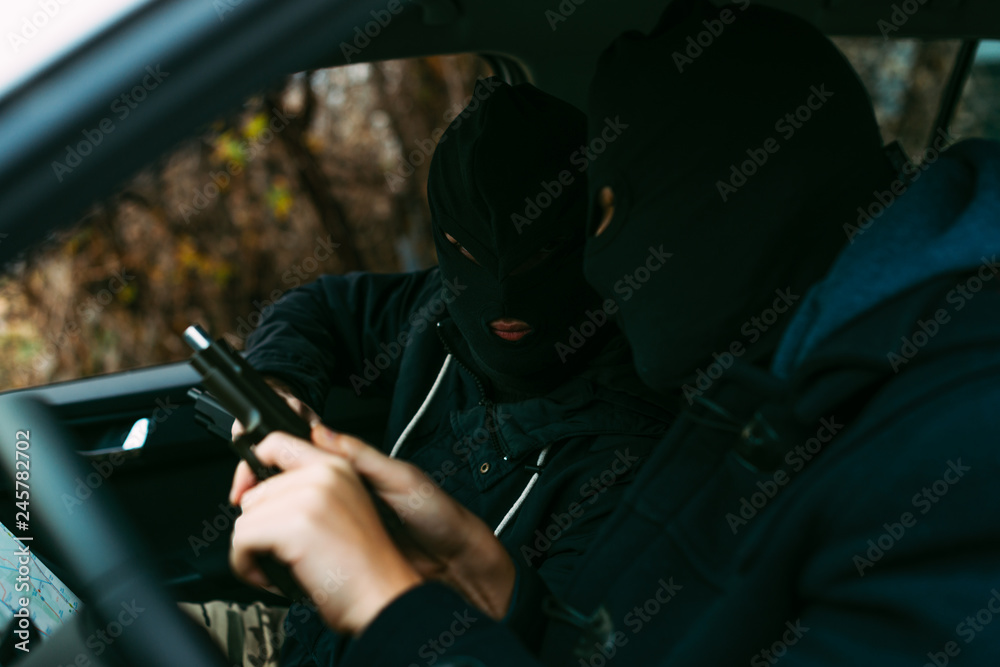 bank robbers putting their mask on prepared to do their next robbery ...