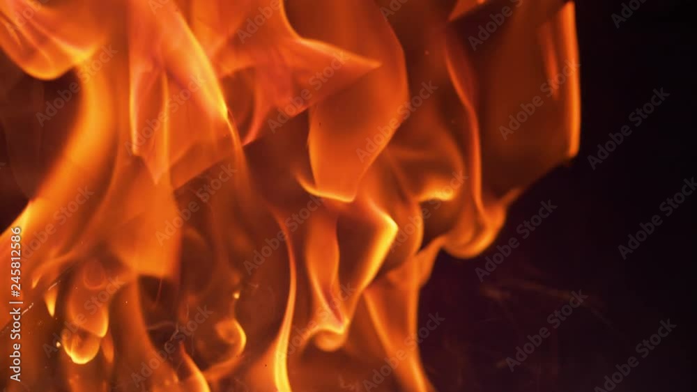 SLOW MOTION, MACRO, DOF: Cinematic shot of a flaming blade being lifted ...