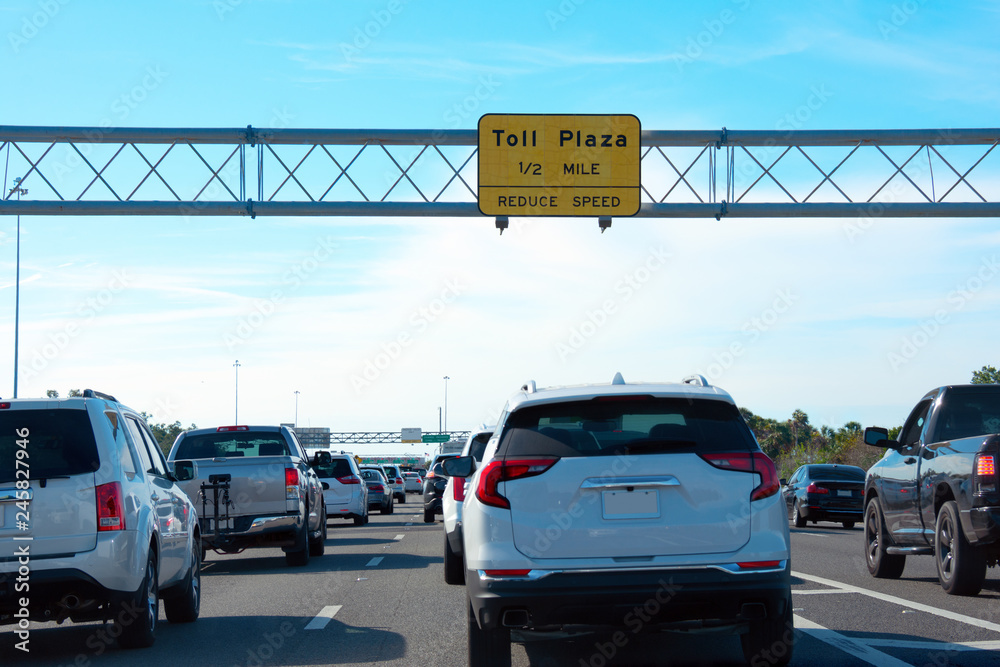 Toll Plaza 1/2 MILE yellow sign on overhead metal tri-chord truss with ...