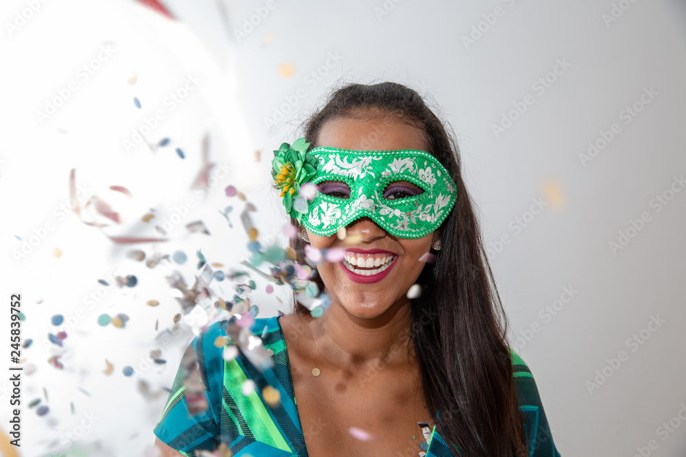 people, holidays, emotion and carnival concept - happy young woman with ...