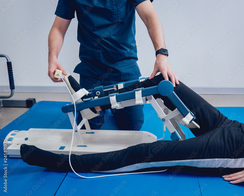 Patient on CPM (continuous passive range of motion) machines. Device to ...