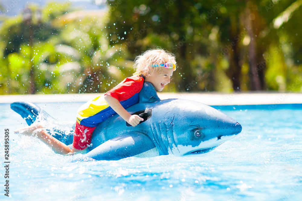 Child in swimming pool. Kid on inflatable float Stock Photo | Adobe Stock