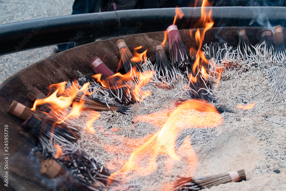 線香のお焚き上げ Senko, incense sticks, on fire at Japanese temple for praying ...