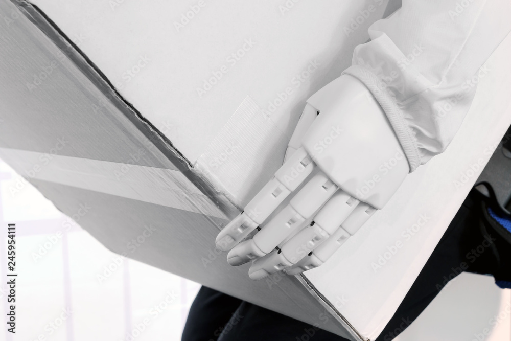 Robot arm carry heavy box. Robotic wearable muscle suit and artificial ...