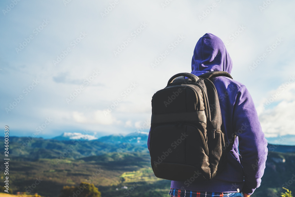 tourist traveler with black backpack on background top mountain ...
