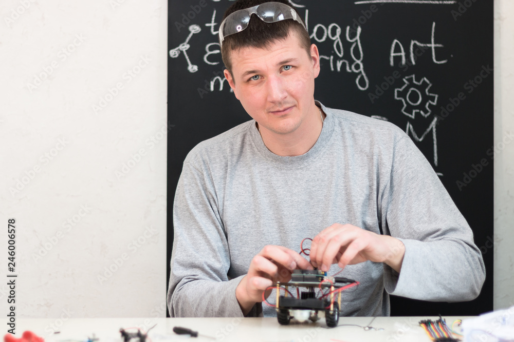 Photo & Art Print A teacher shows to children how to collect a handmade ...