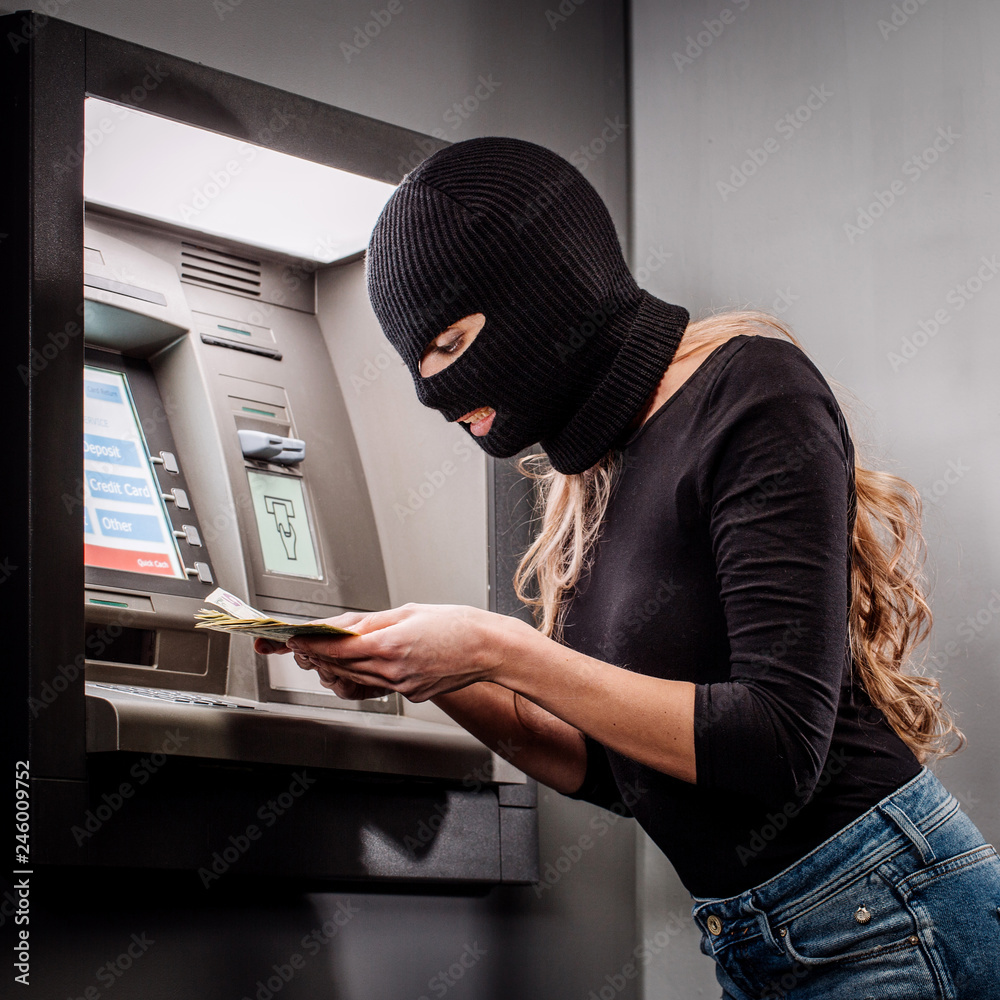 female thief robs an ATM Stock Photo | Adobe Stock