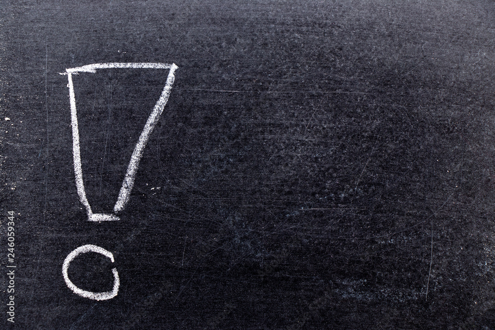 White color chalk hand drawing in exclamation mark with blank space ...