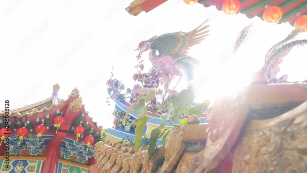 Camera movement reveals a backlit phoenix. Lens flare is created by the ...