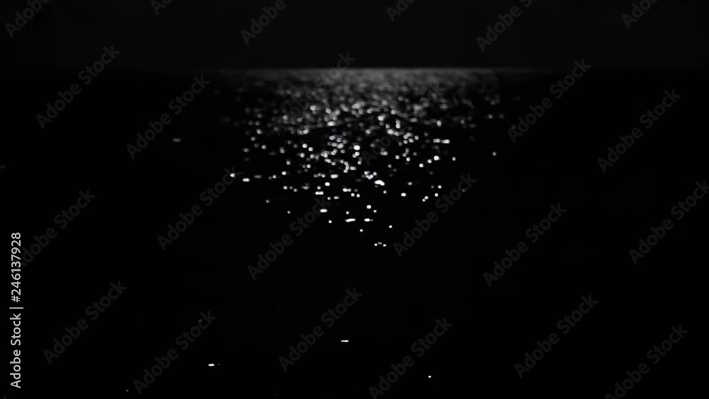 Bright moonlight flashes on the dark sea water, the reflection of the ...