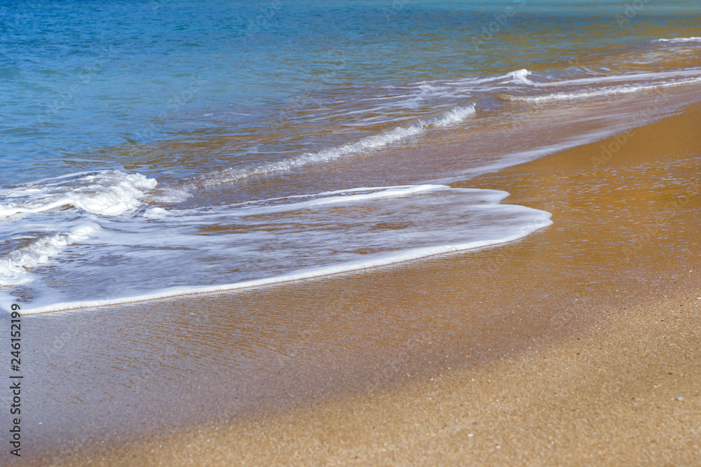 Surf and tide of foamy waves on a sandy beach. Sunny sandy Livadi beach ...