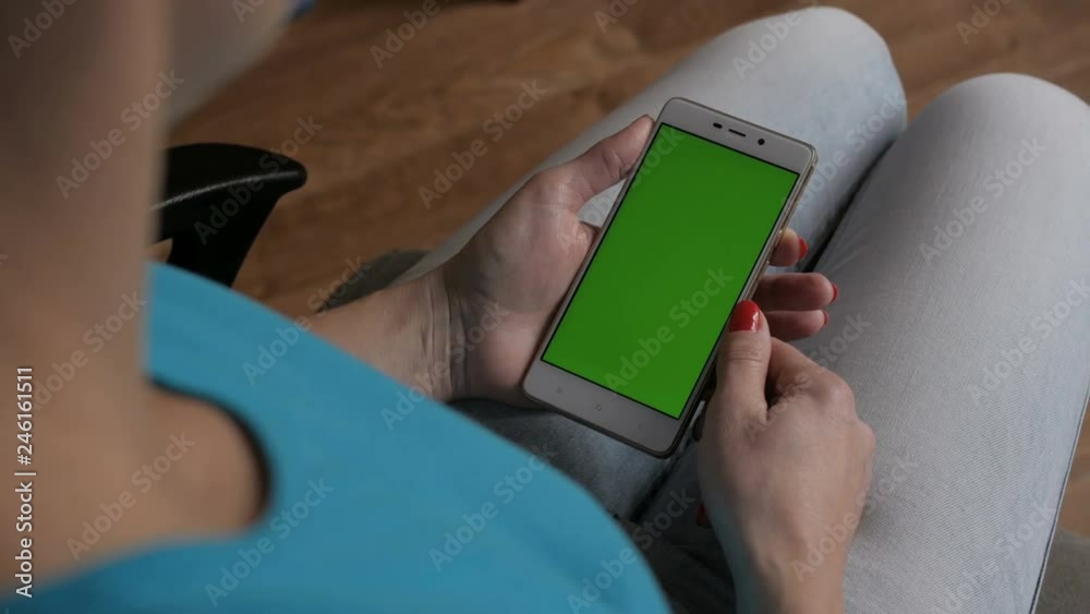 Girl using cell phone. Woman holding a smartphone in the hands of a ...