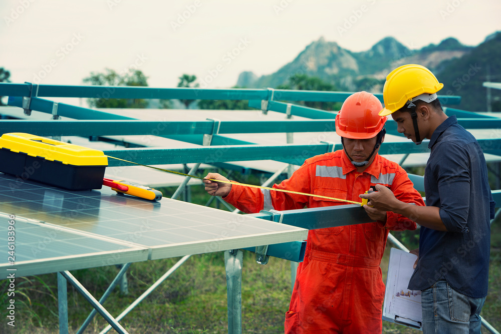 Electrical engineers are installing solar panels. To produce ...