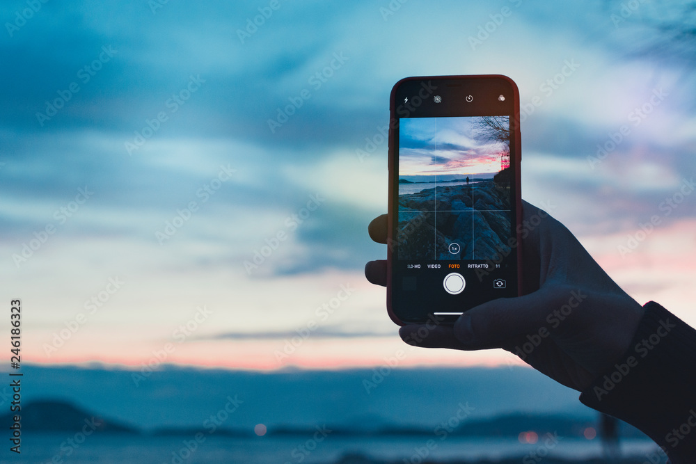 hand holding smart phone with landscape background with copy space ...