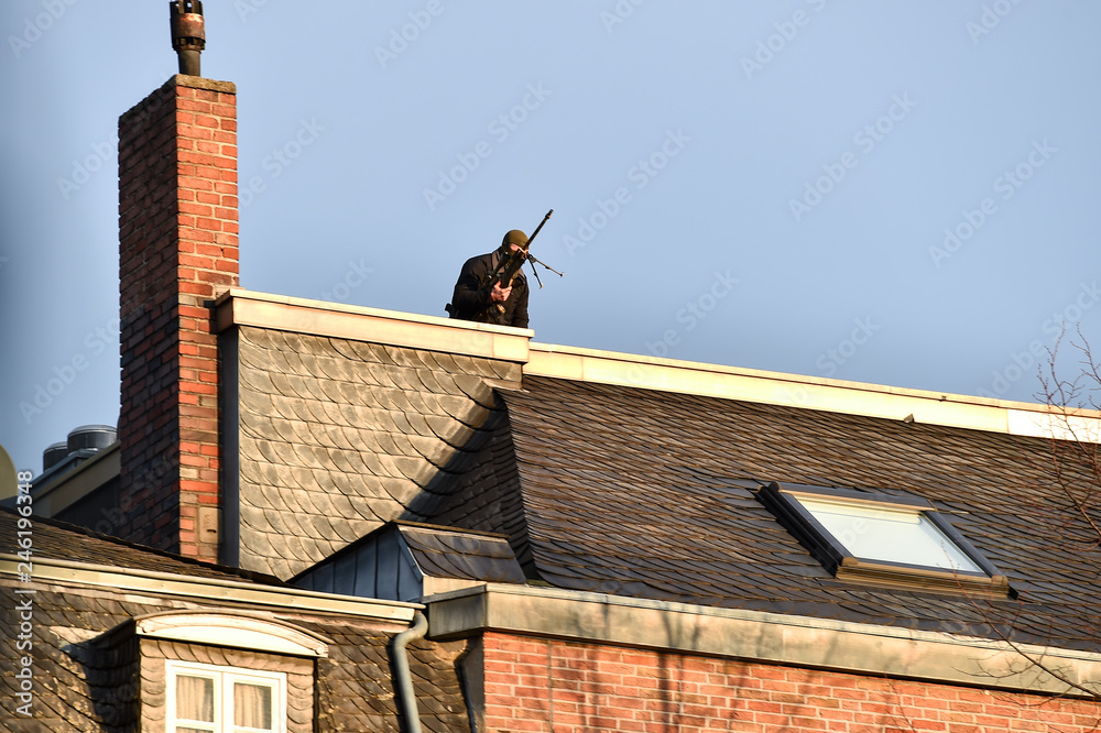 sniper securing a perimeter from a rooftop Stock Photo | Adobe Stock