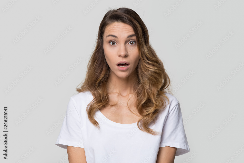 Shocked stunned young woman feeling astonished looking at camera ...