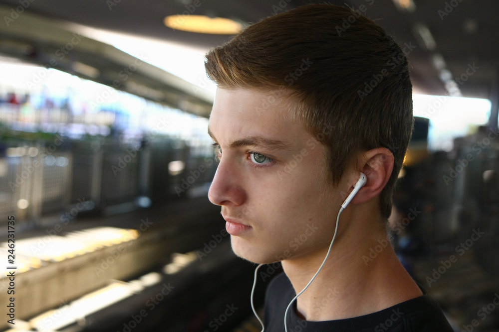 Teenage Boy At Railway Station With Earbuds Stock Photo | Adobe Stock