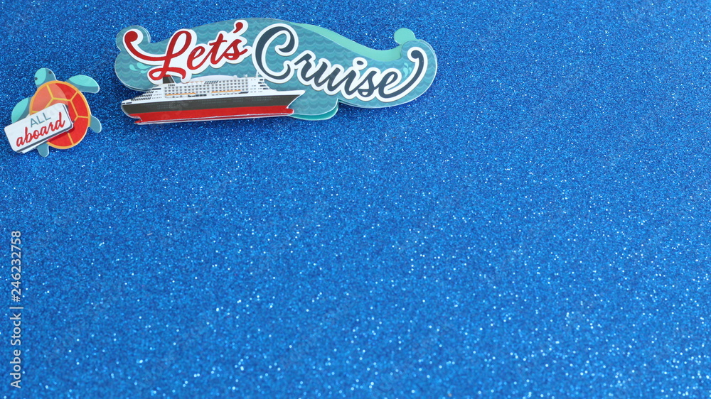 Lets cruise written on a banner with a cruise ship at sea written on a ...