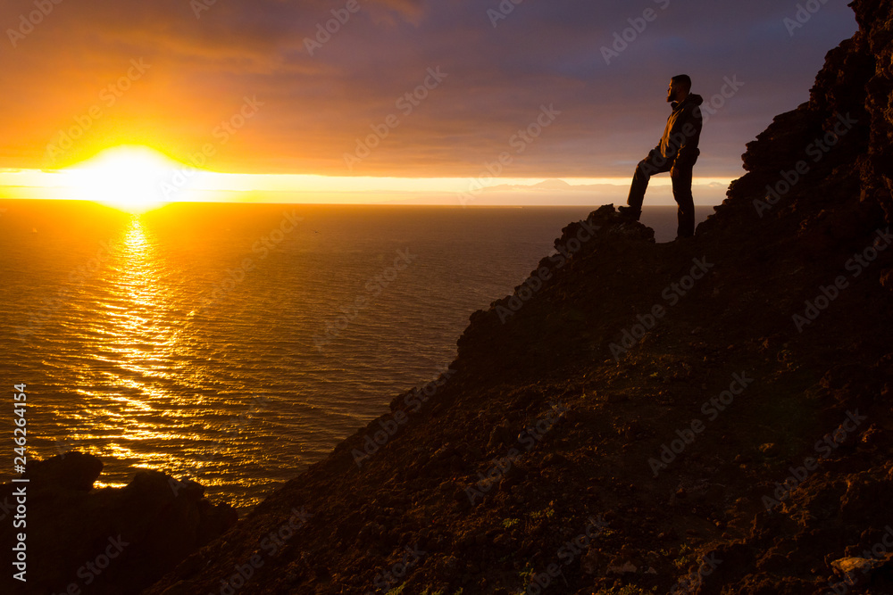 Man Standing Alone On Cliff
