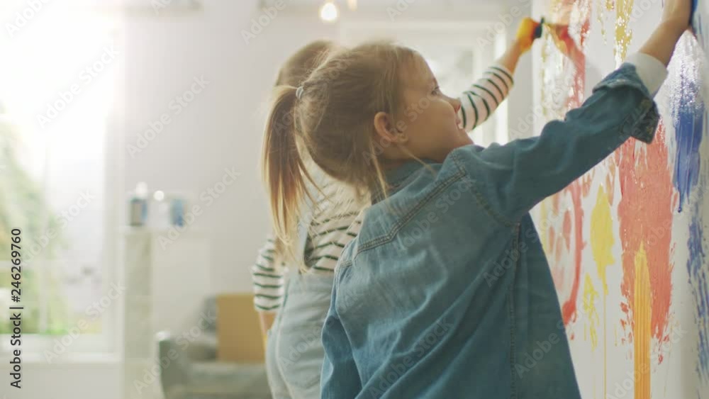 Two Happy Little Girls with Hands Dipped in Colorful Paint Put ...