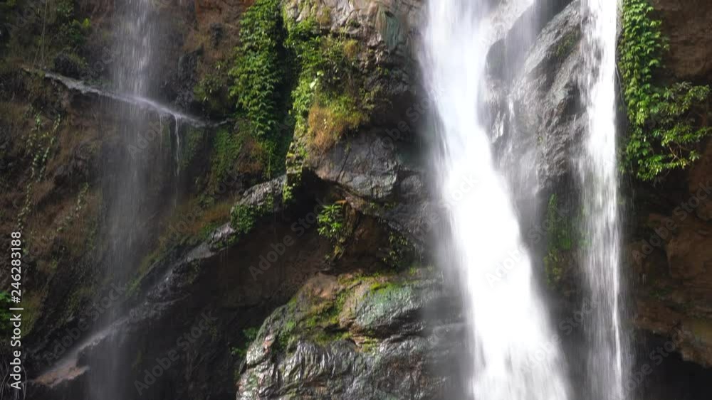 Amazing waterfall hidden in the tropical rainforest jungle in the form ...
