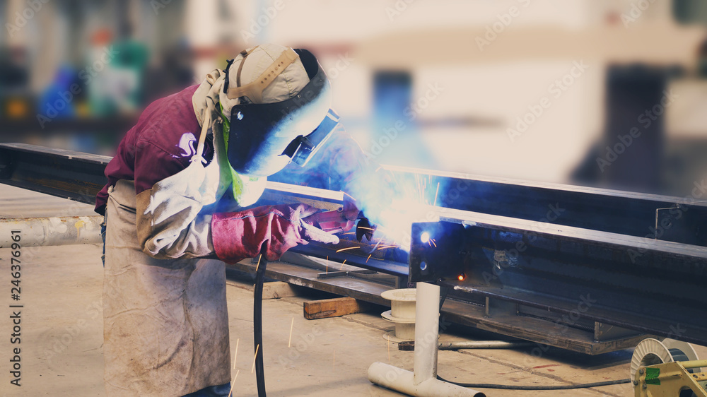 Welder is welding flux cored arc welding ,Industrial welding part in ...